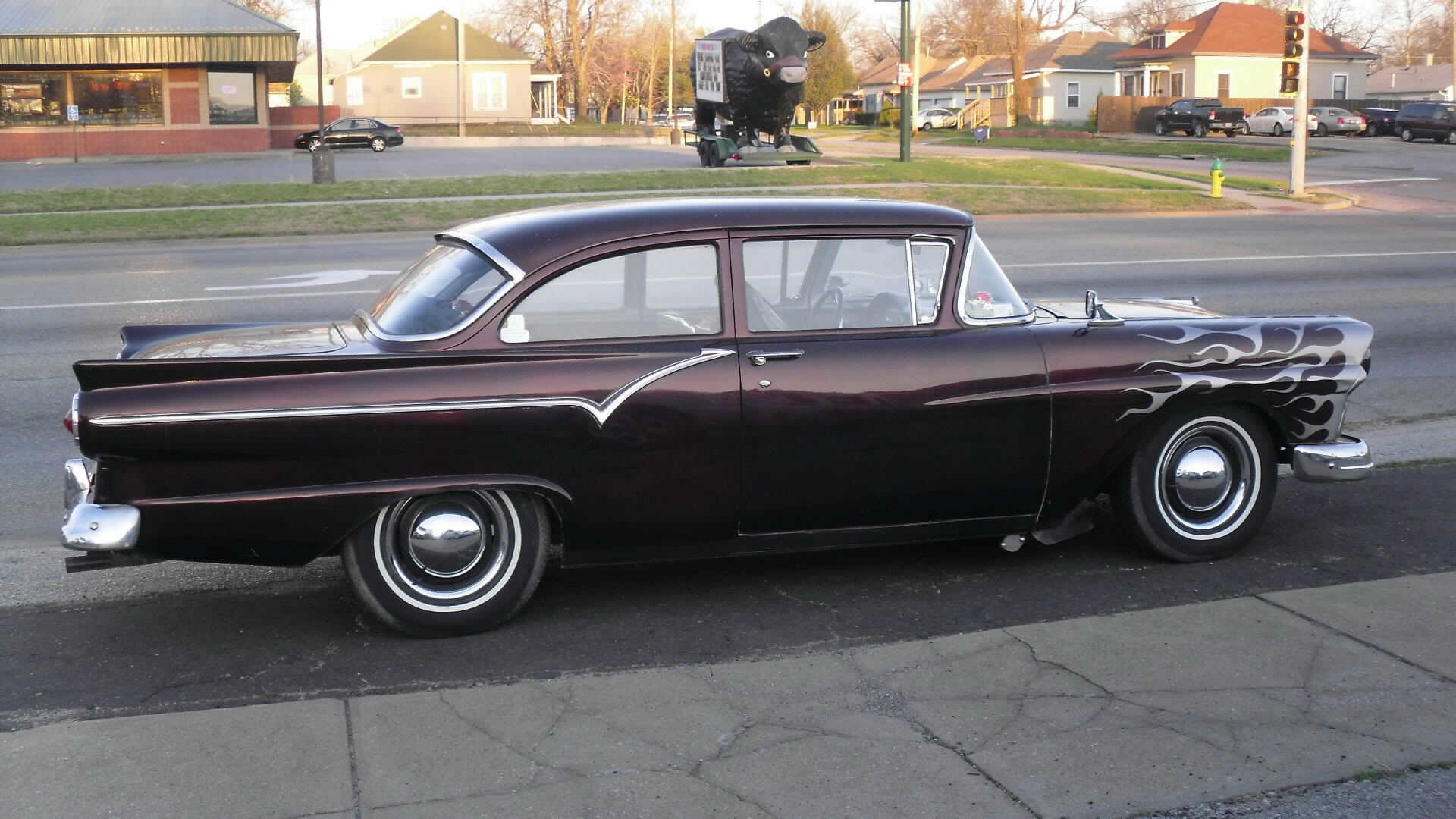 Dark burgundy, red vinyl interior, V-8, 4 speed, two-door post, newer tires