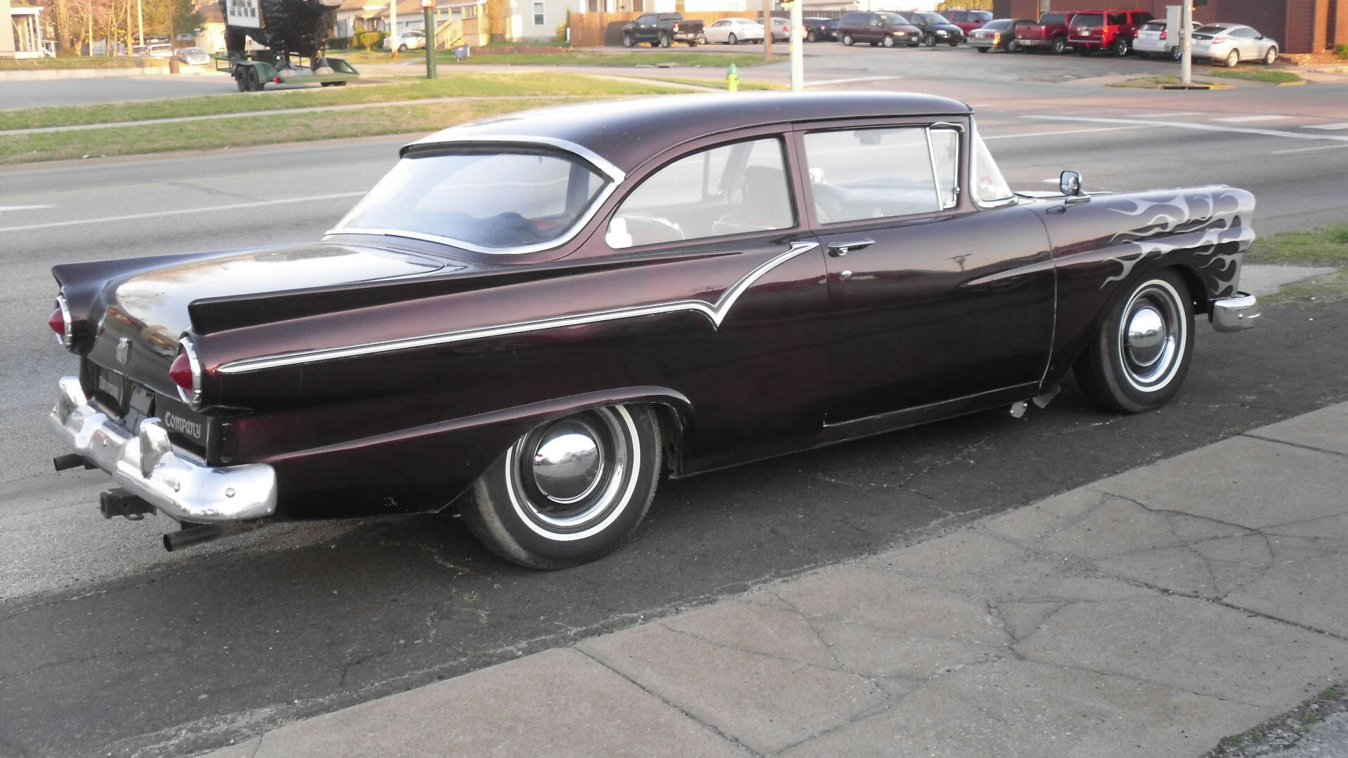 Dark burgundy, red vinyl interior, V-8, 4 speed, two-door post, newer tires